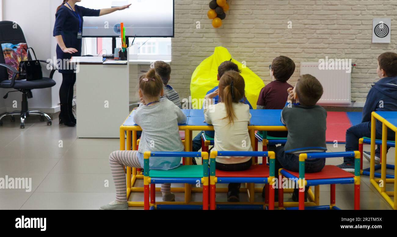 The teacher conducts a lesson for a group of preschoolers in a children ...