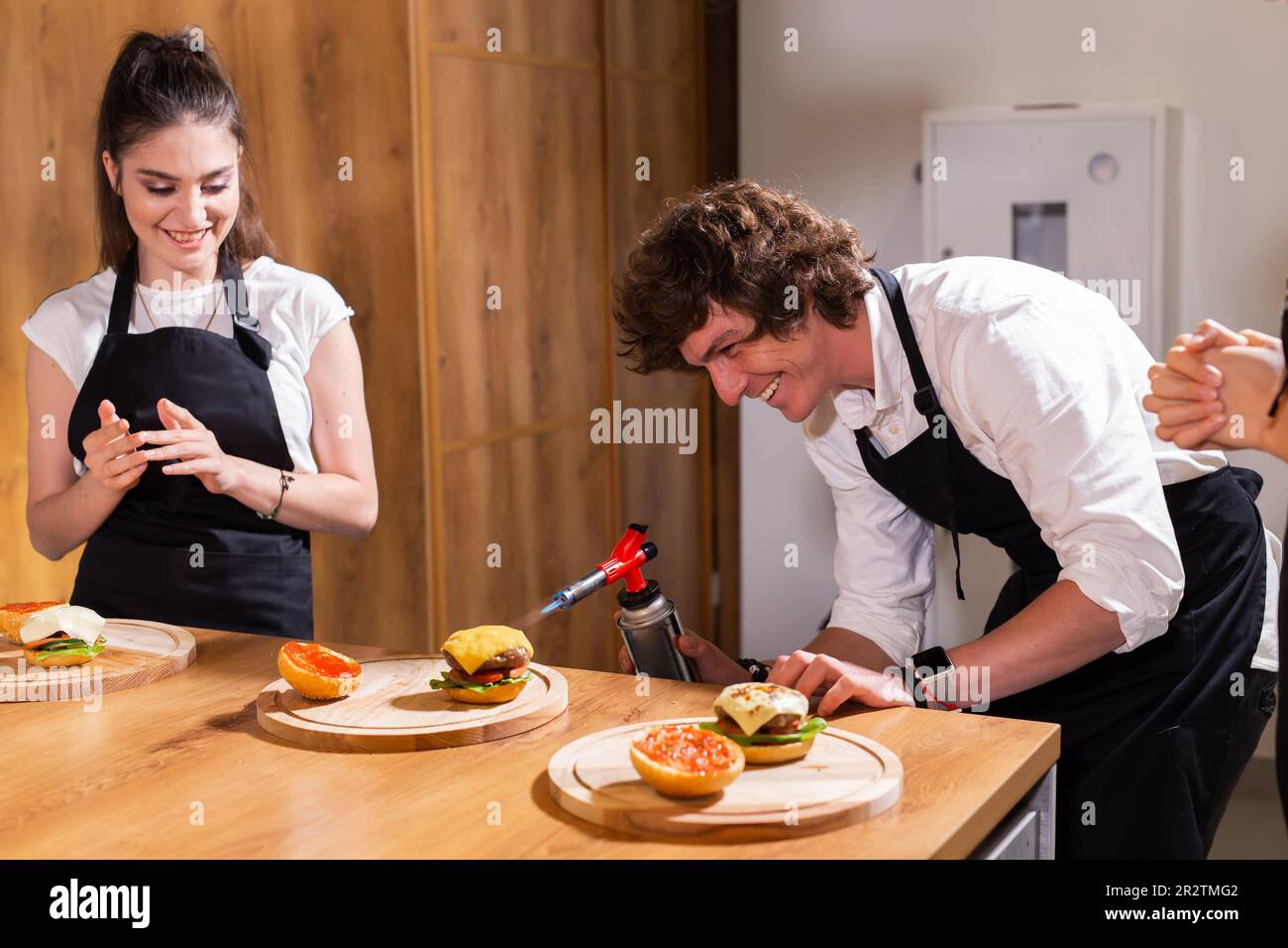 Preparing delicious burgers. Chef cooking meat burgers with beef ...