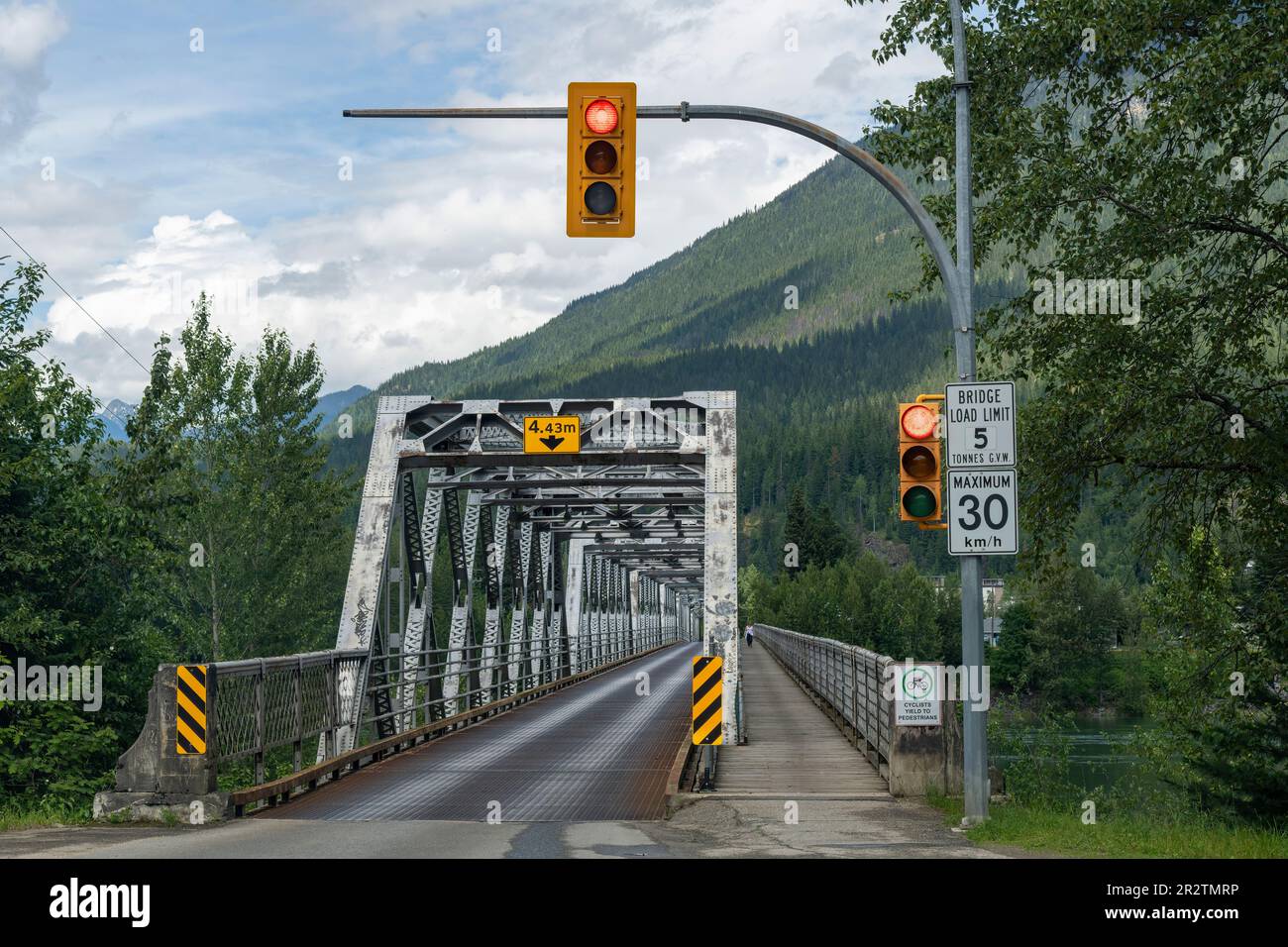 Drivers perspective of steel truss bridge across river in mountainous ...