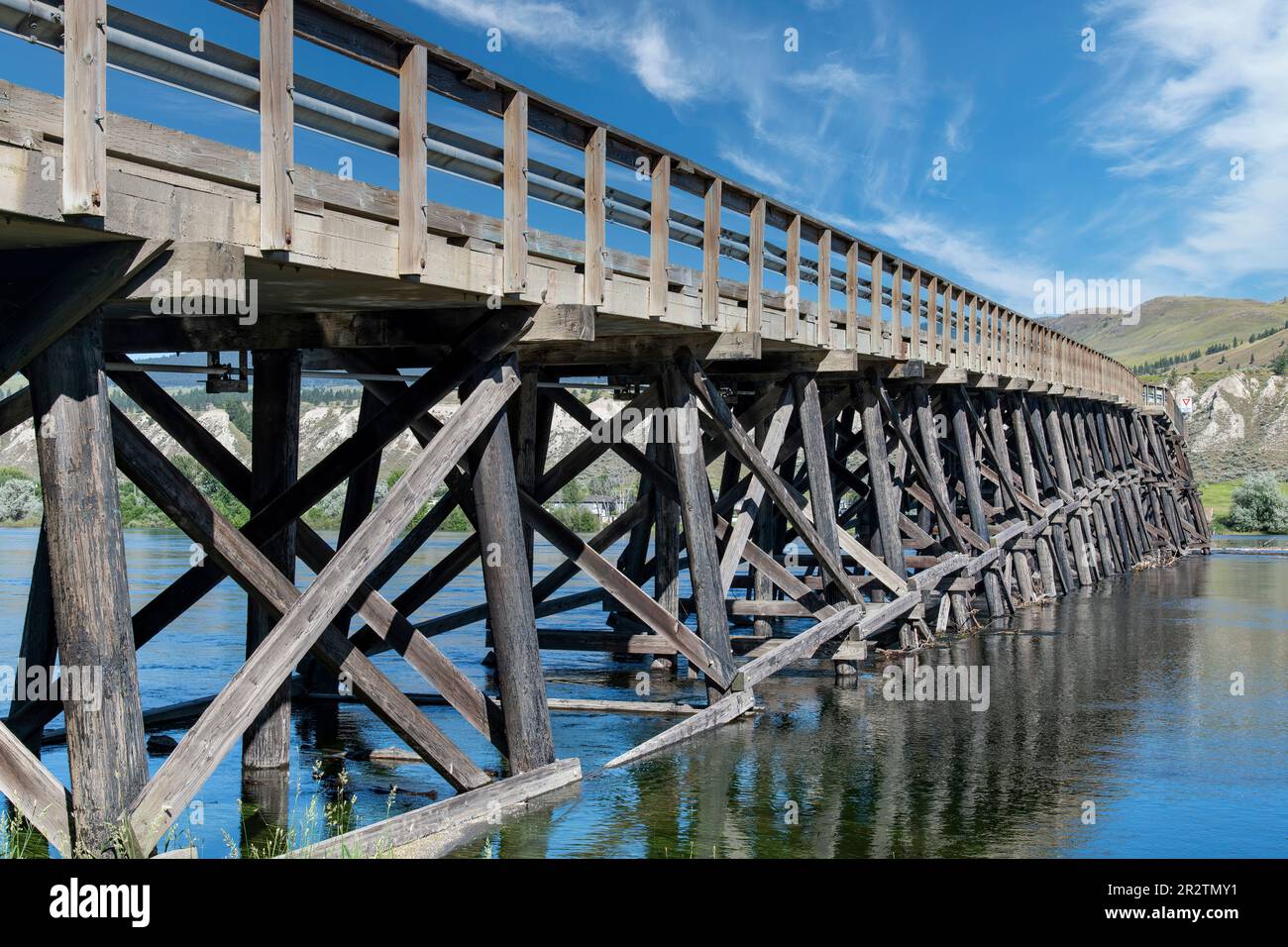 Low angle view at river level of wooden Pritchard Bridge across ...