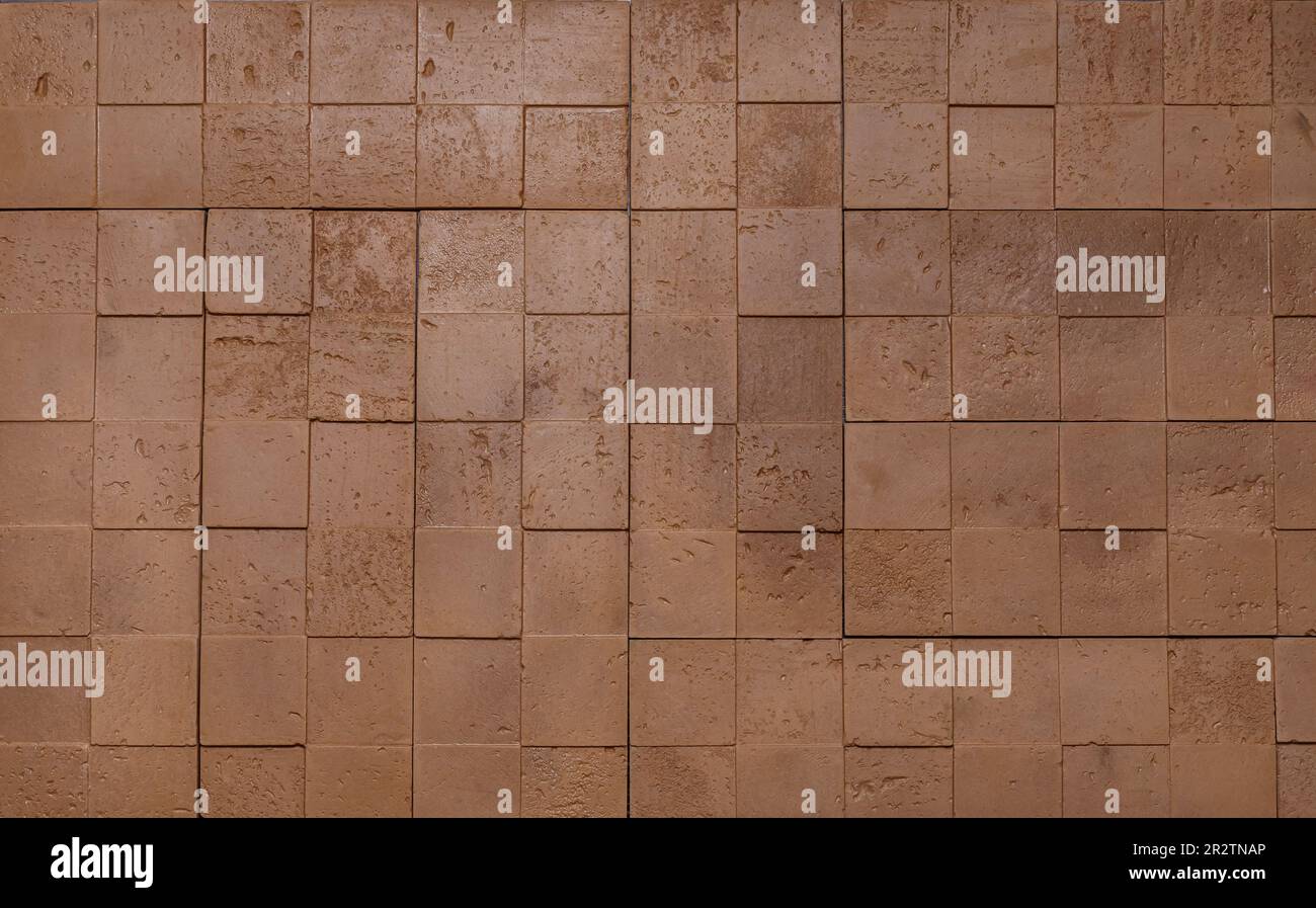 The texture of the wall is made of beige natural stone blocks or brick ...