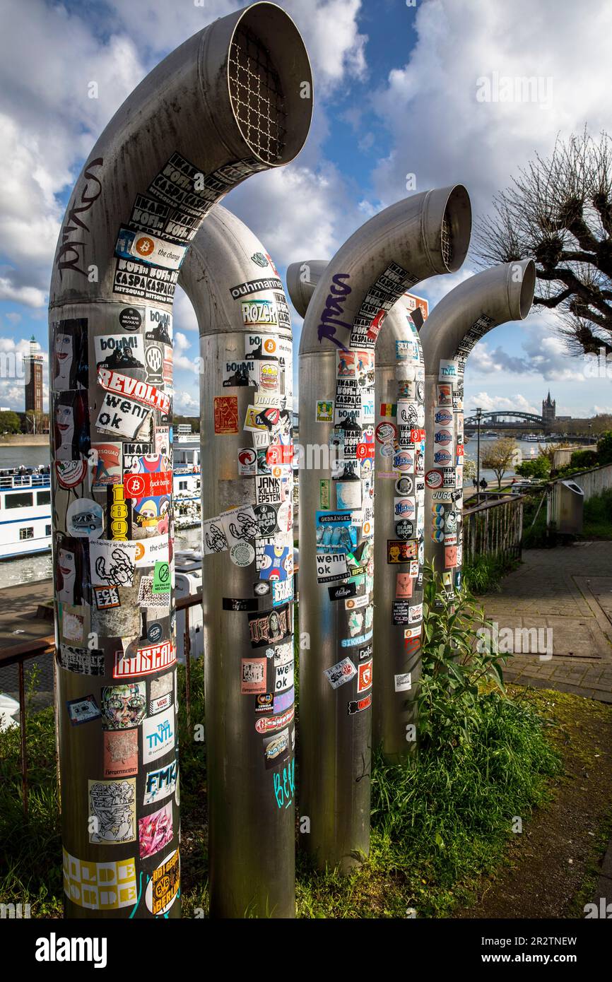ventilation pipes on the banks of the Rhine covered with many stickers ...