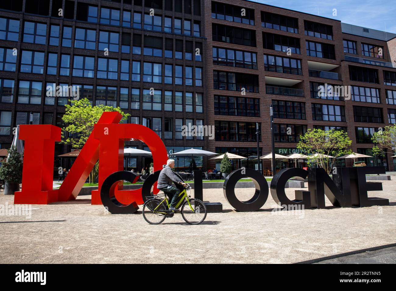 logo of the town quarter I/D Cologne in front of the buildings Haus am ...