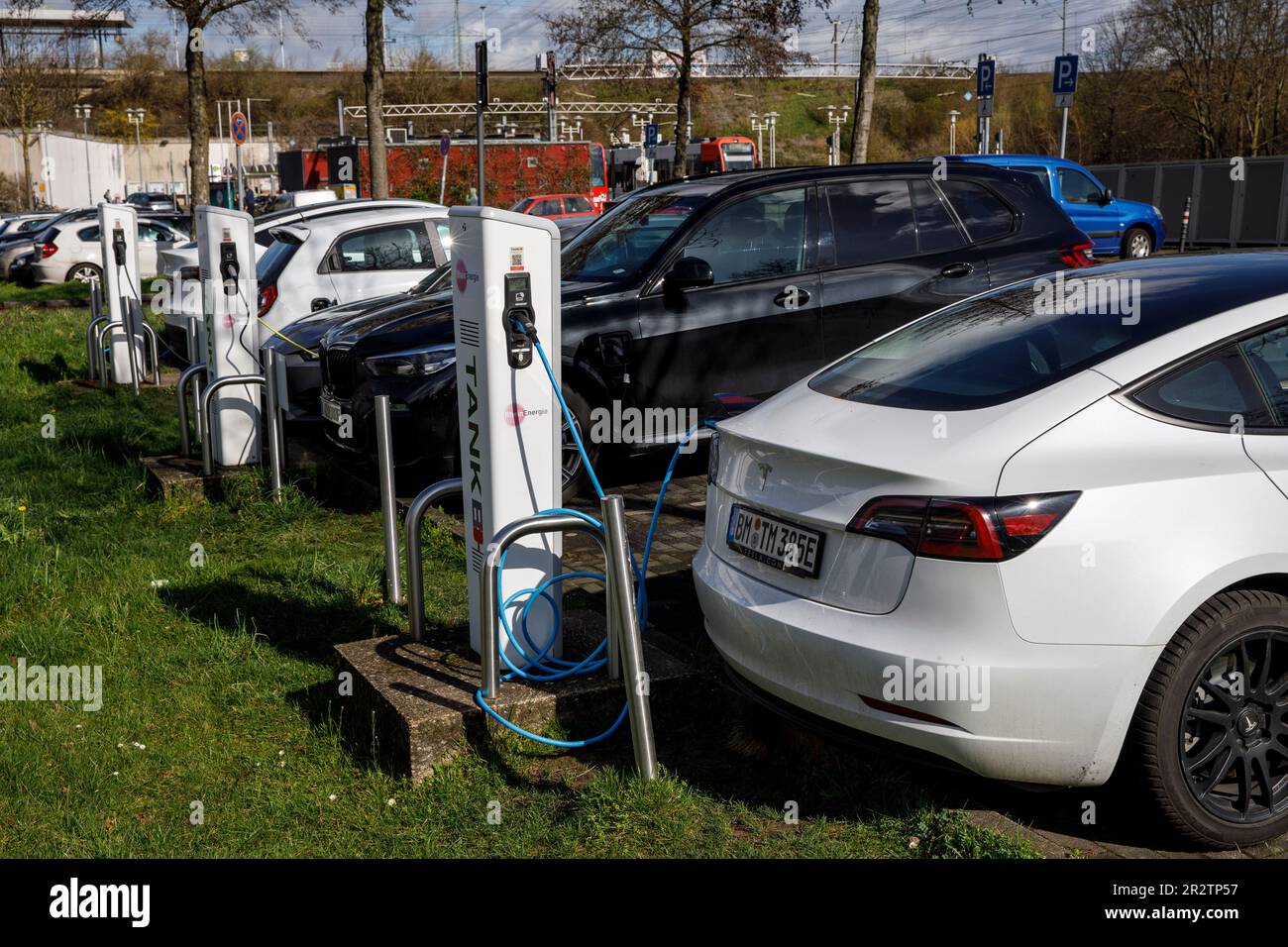 Germany, Cologne, a Tesla at a charging station for electric cars at ...