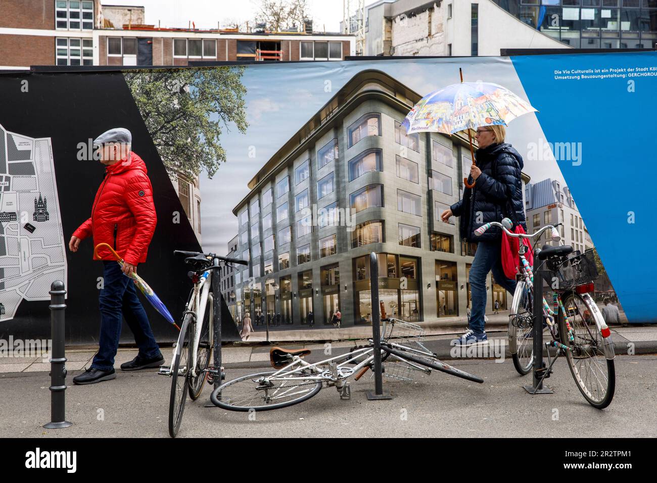 people pass a construction fence at the building site of Laurenz-Carré ...
