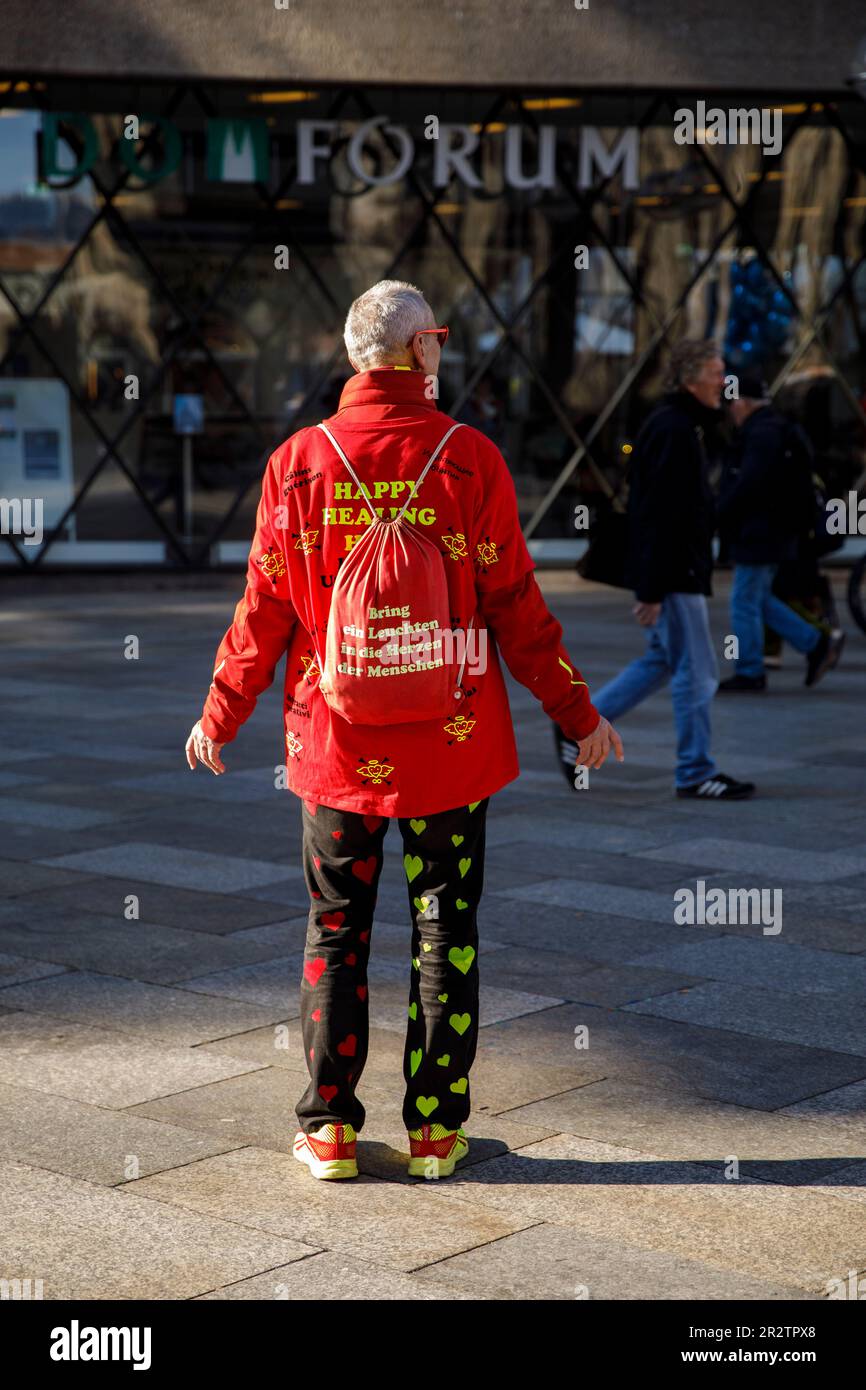 wearing a jacket with the inscription Happy Healing Hugs a man stands ...