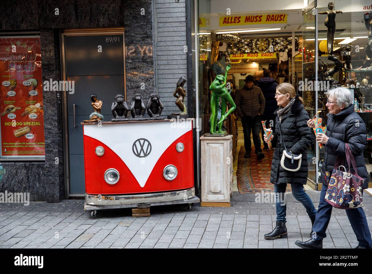 women passing the display of a furniture store on the shopping street ...