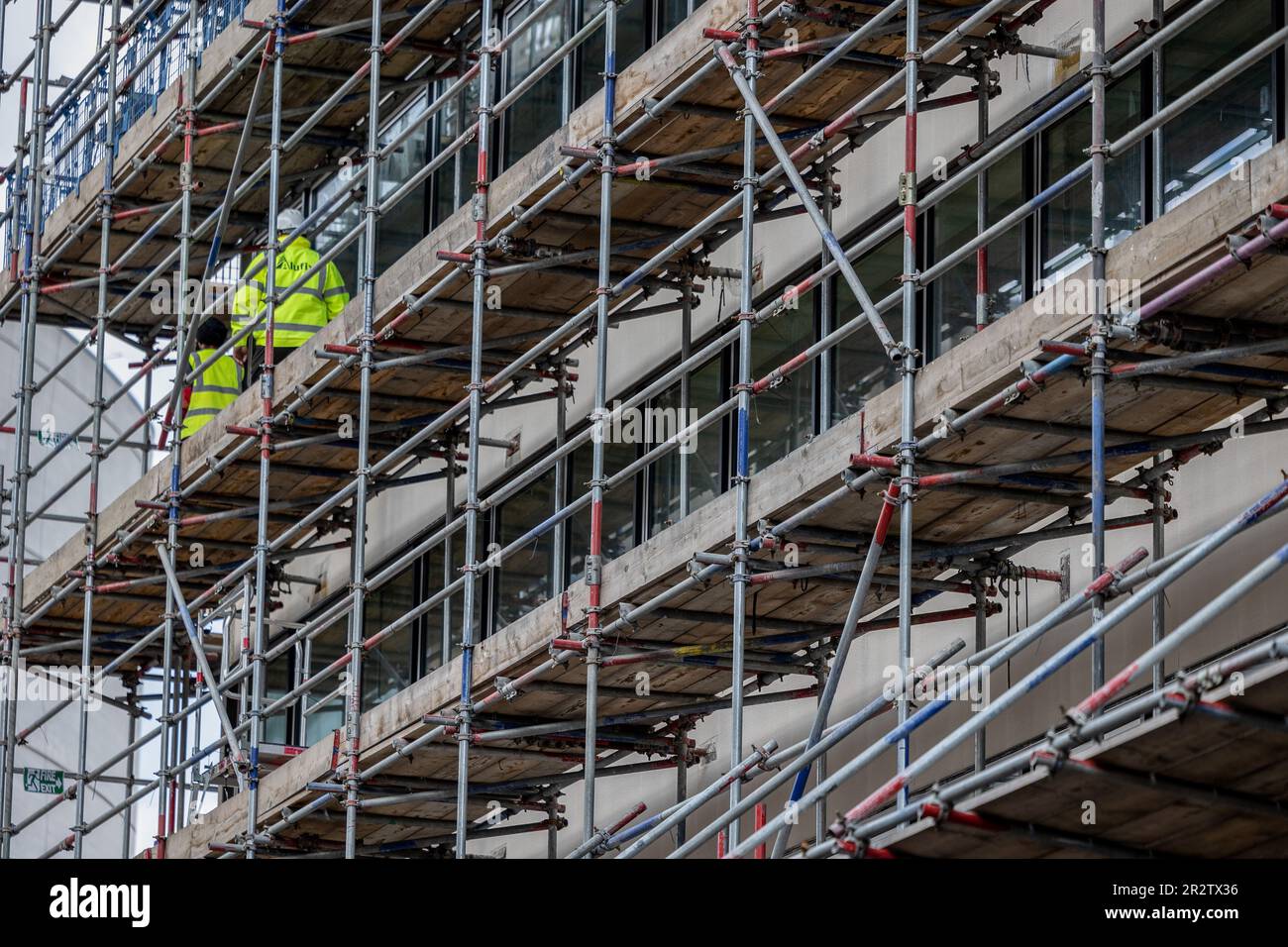 London, UK. 20th May, 2023. Construction workers are seen walking on ...