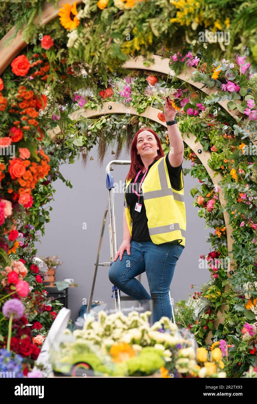 Melissa Pauley makes adjustments to floral arches in the Capel Manor ...