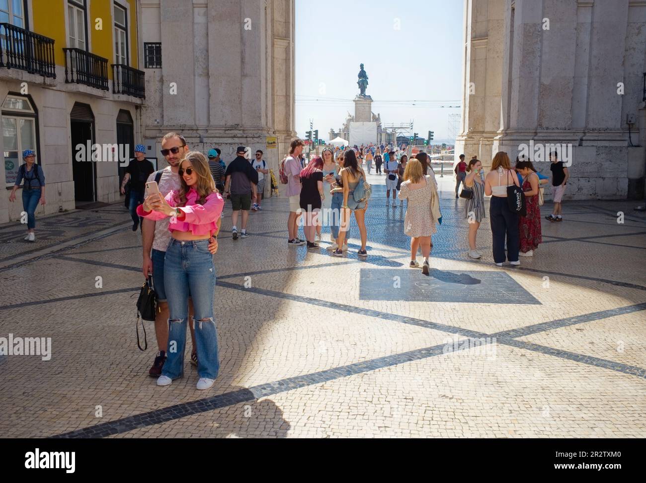 An influencer and companion who is holding her handbag pose for a ...