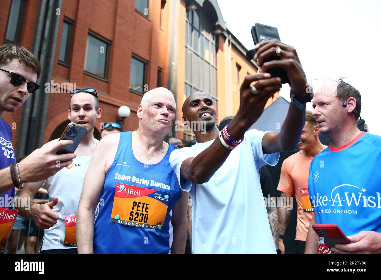 Sir Mo Farah poses with fans at the finish line of the 10k mens elite ...
