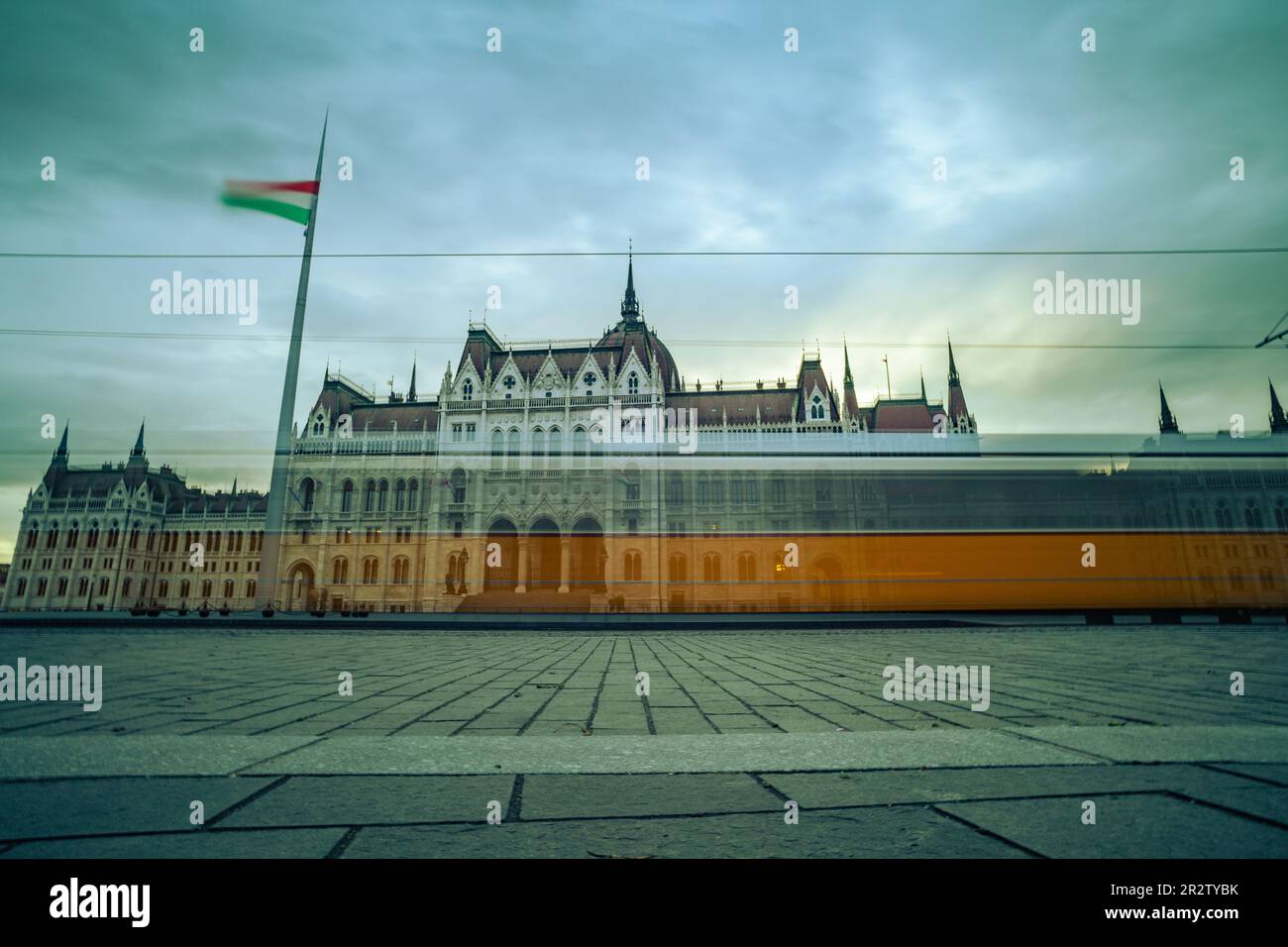 Long exposure of National Assembly with passing tram and hungarian flag, Budapest, Hungary, 2023 ...