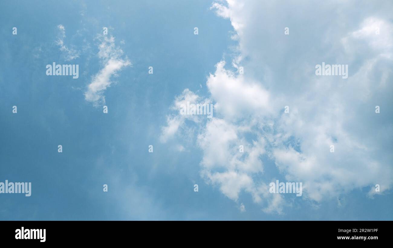 Time-lapse shot of a blue sky and moving white clouds in the air ...