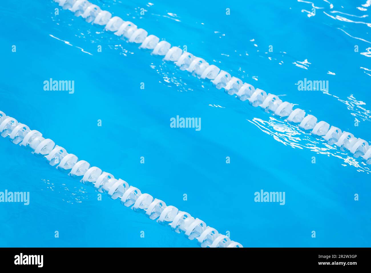 The view of an empty public swimming pool indoors. Lanes of a ...