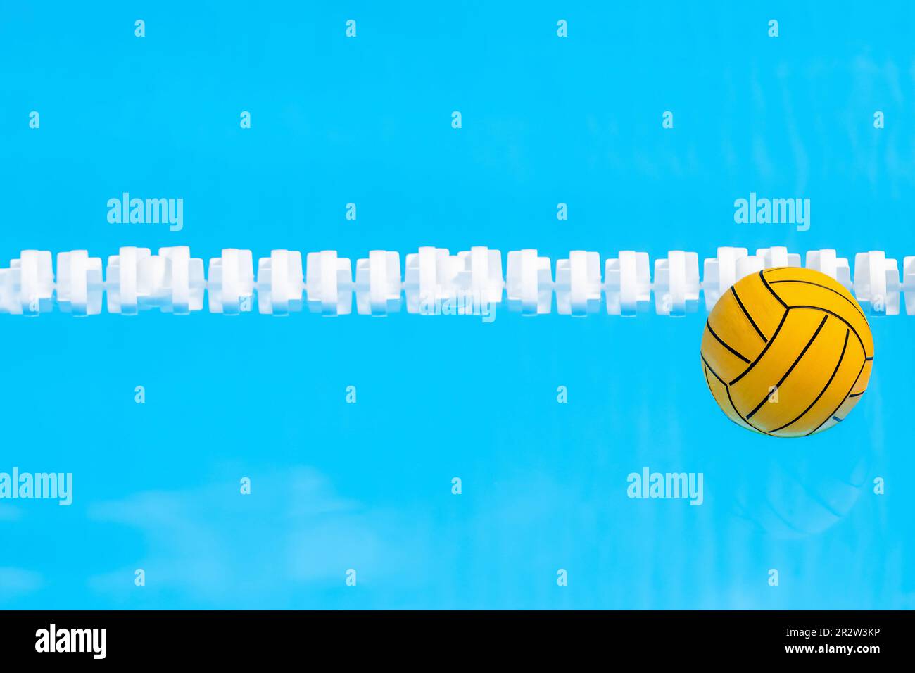 Yellow water polo ball on swimming pool surface for game, competition ...