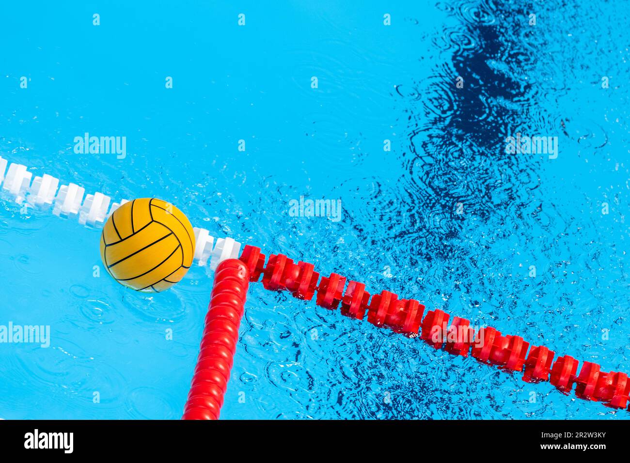 Yellow water polo ball on swimming pool surface for game, competition ...