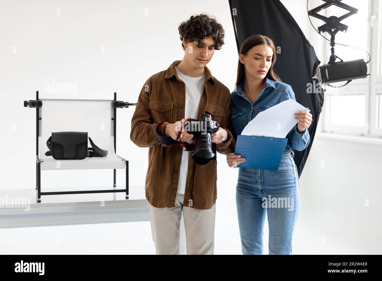 Photography partners. Male photographer and female assistant at work ...