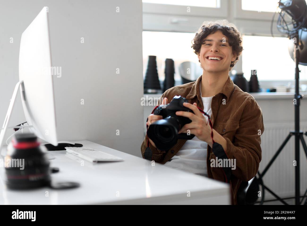 Professional photographer young man working on photo shoot at studio ...