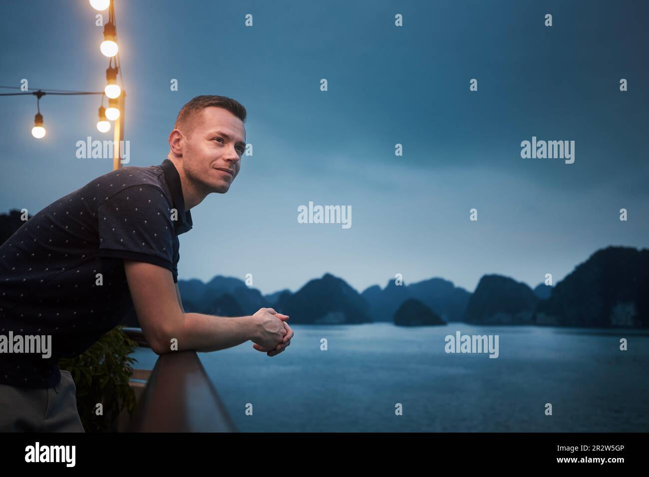 Man enjoying magnificent night view from cruise ship between islands ...