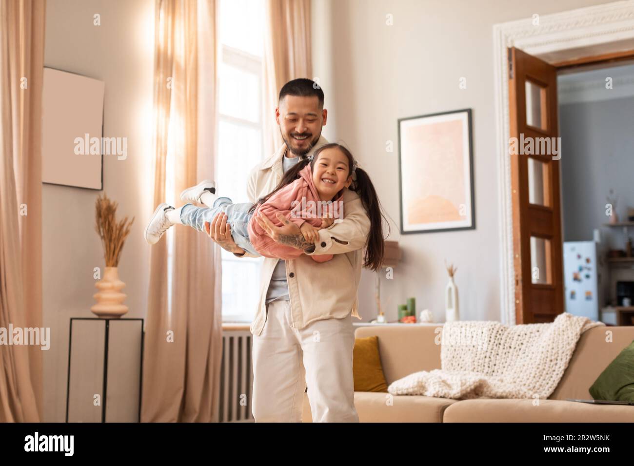 Happy Chinese Father Holding Daughter Playing Having Fun At Home Stock ...