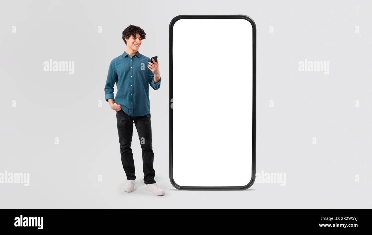 Guy Texting On Phone Standing Near Giant Smartphone, White Background ...