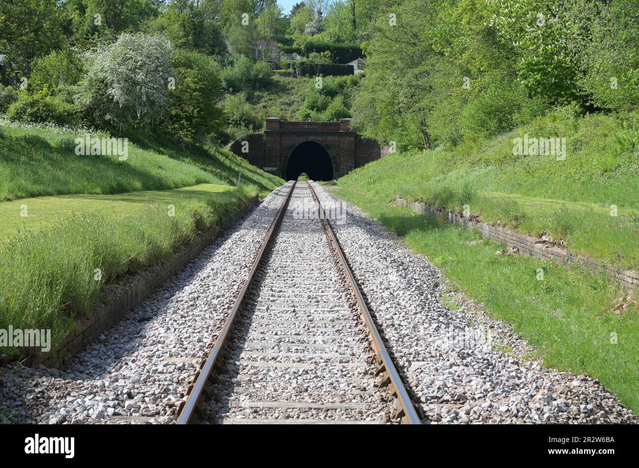 Looking up a single railway track towards a tunnel Stock Photo - Alamy