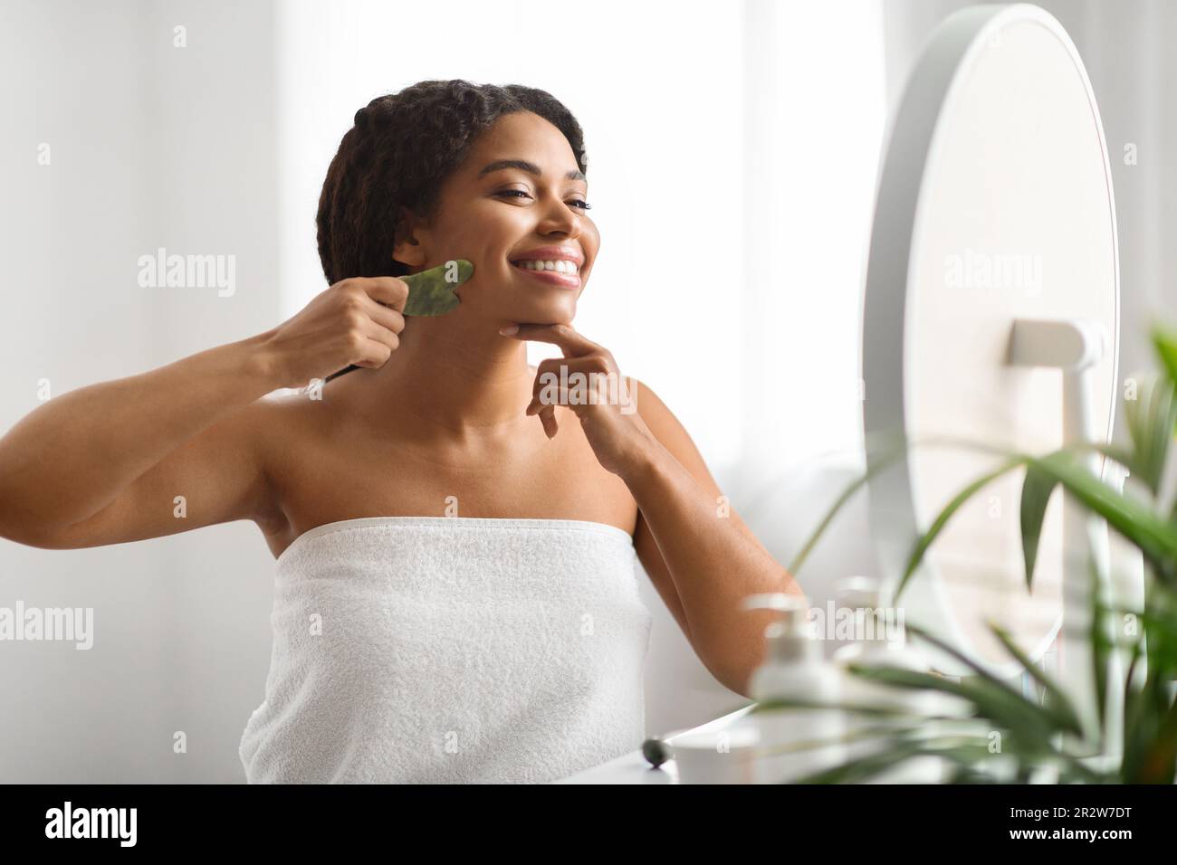 Beauty Tools. Happy Black Female Making Face Massage With Gua Sha ...