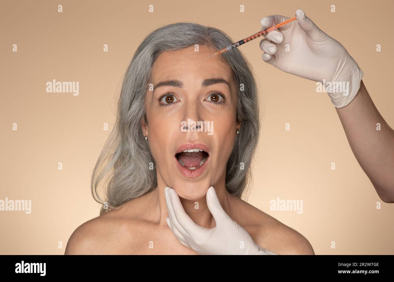 Shocked senior woman receiving beauty shots, using injection medicine ...