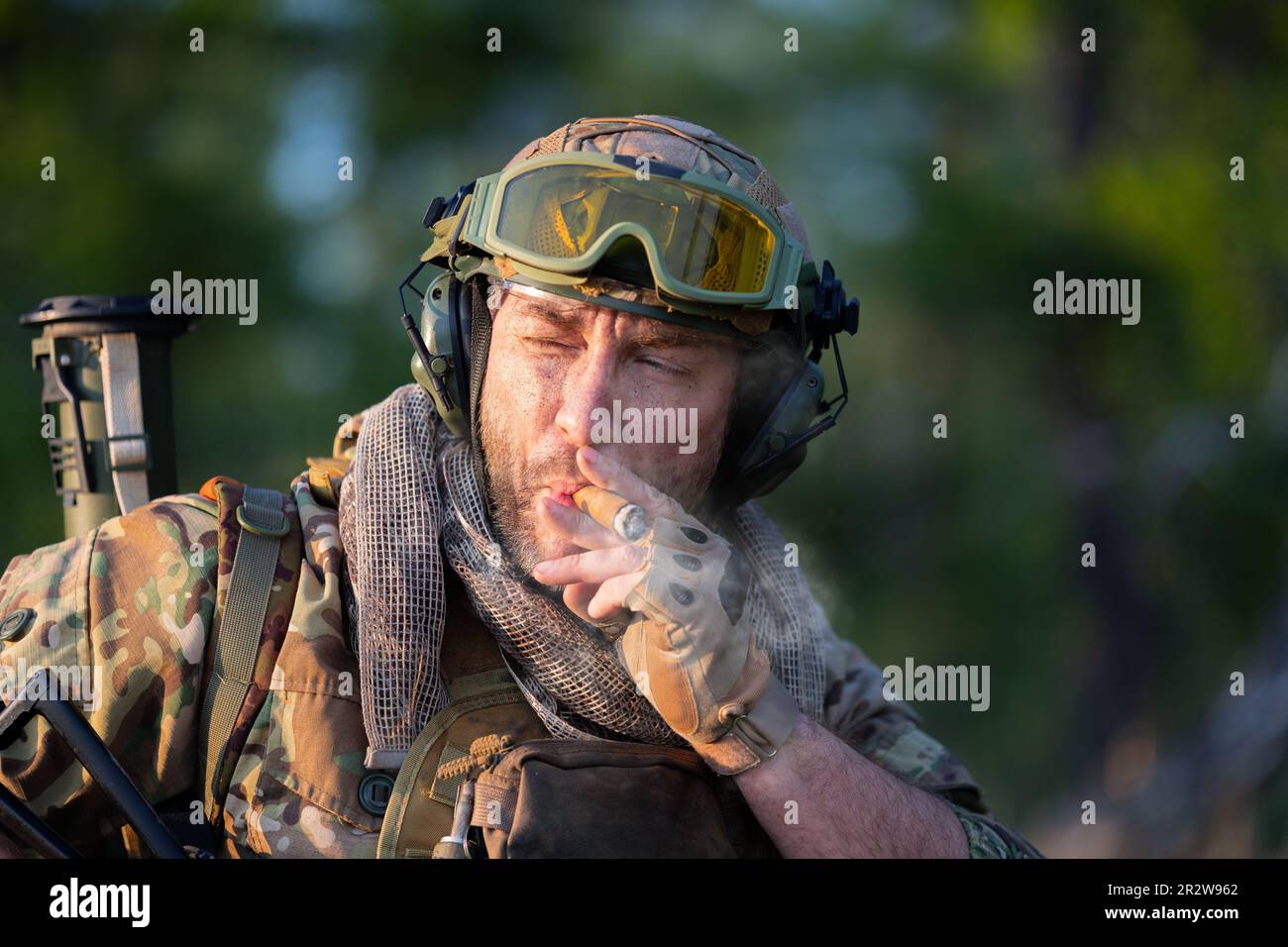Smoking modern mercenary soldier. A bearded middle-aged man in military ...