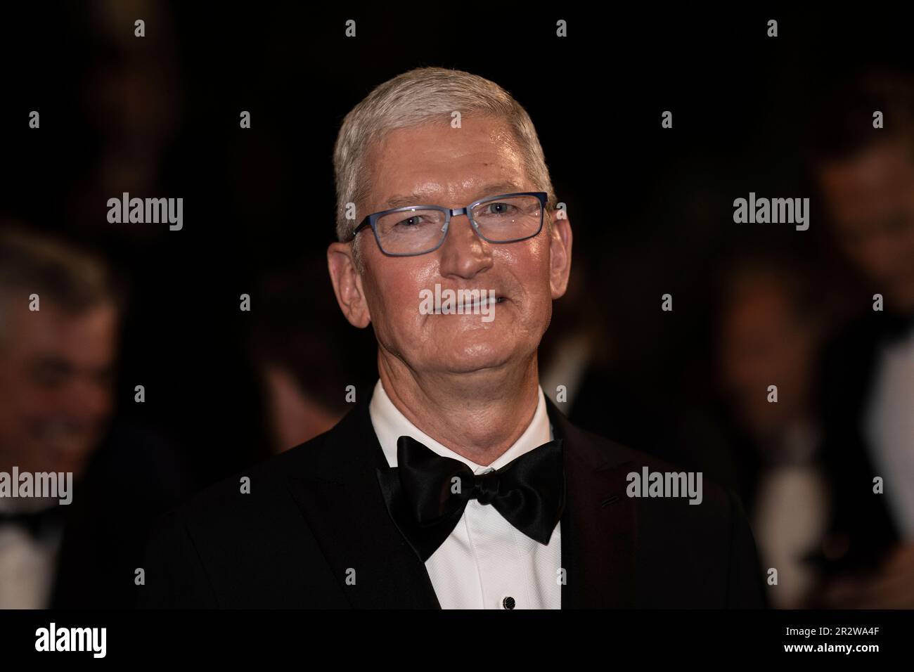 Tim Cook poses for photographers upon departure from the premiere of ...