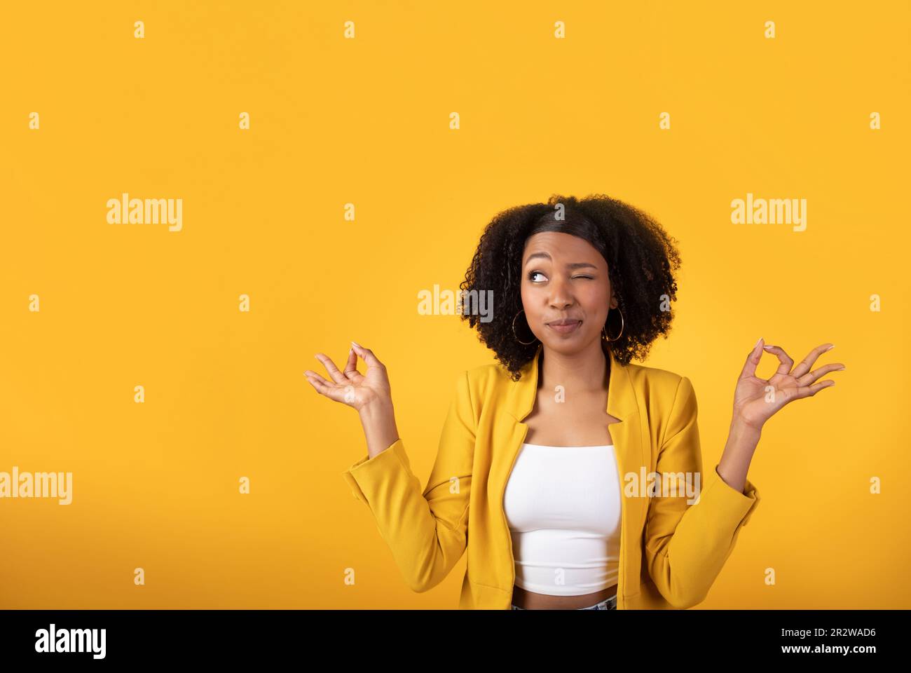 Funny curiously black lady looking with one eye at free space ...