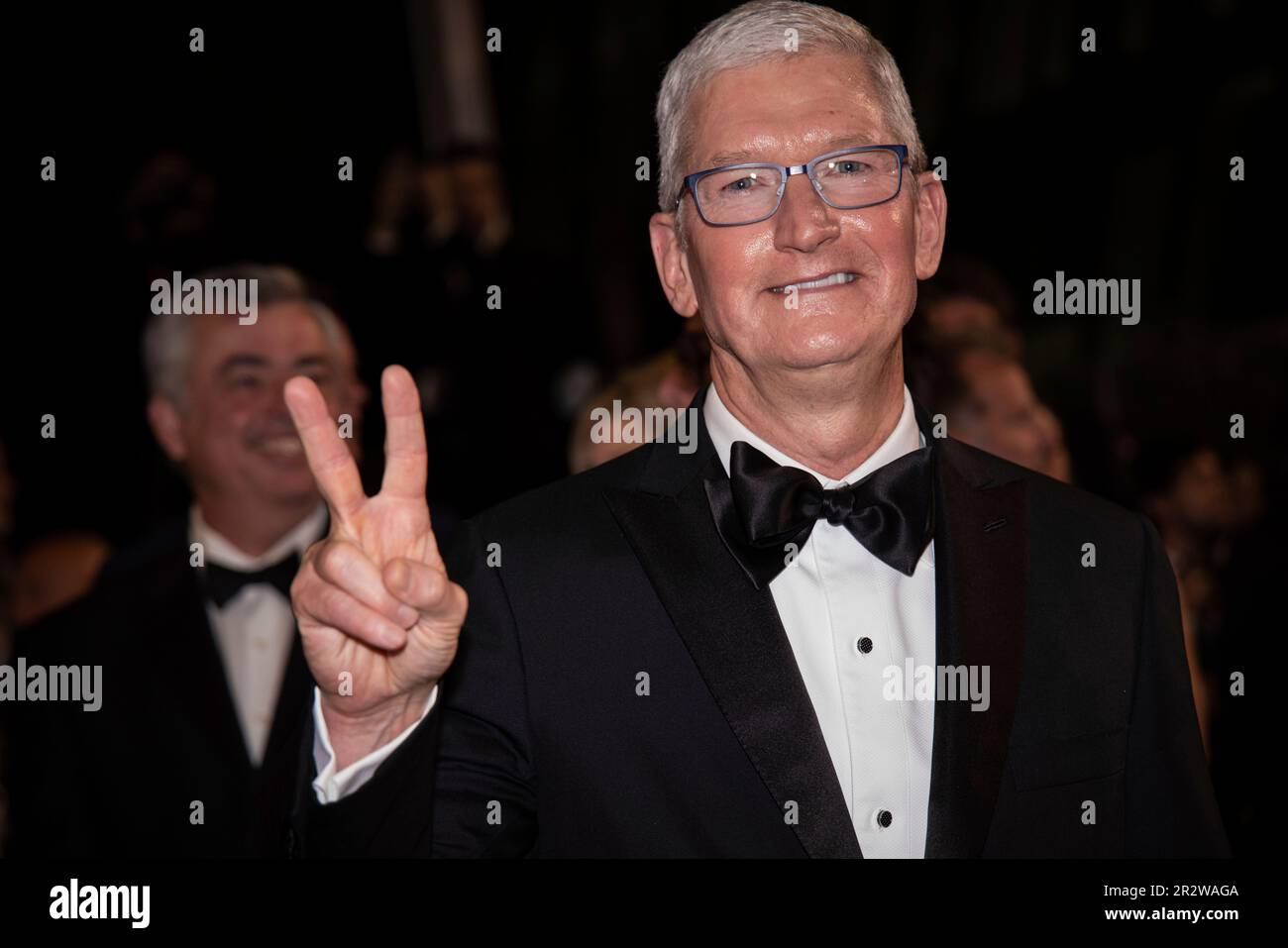 Tim Cook poses for photographers upon departure from the premiere of ...
