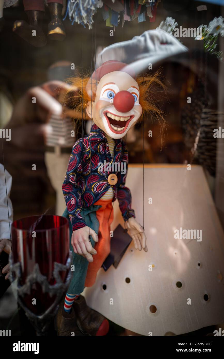 A clown puppet hangs in a shop window Stock Photo - Alamy