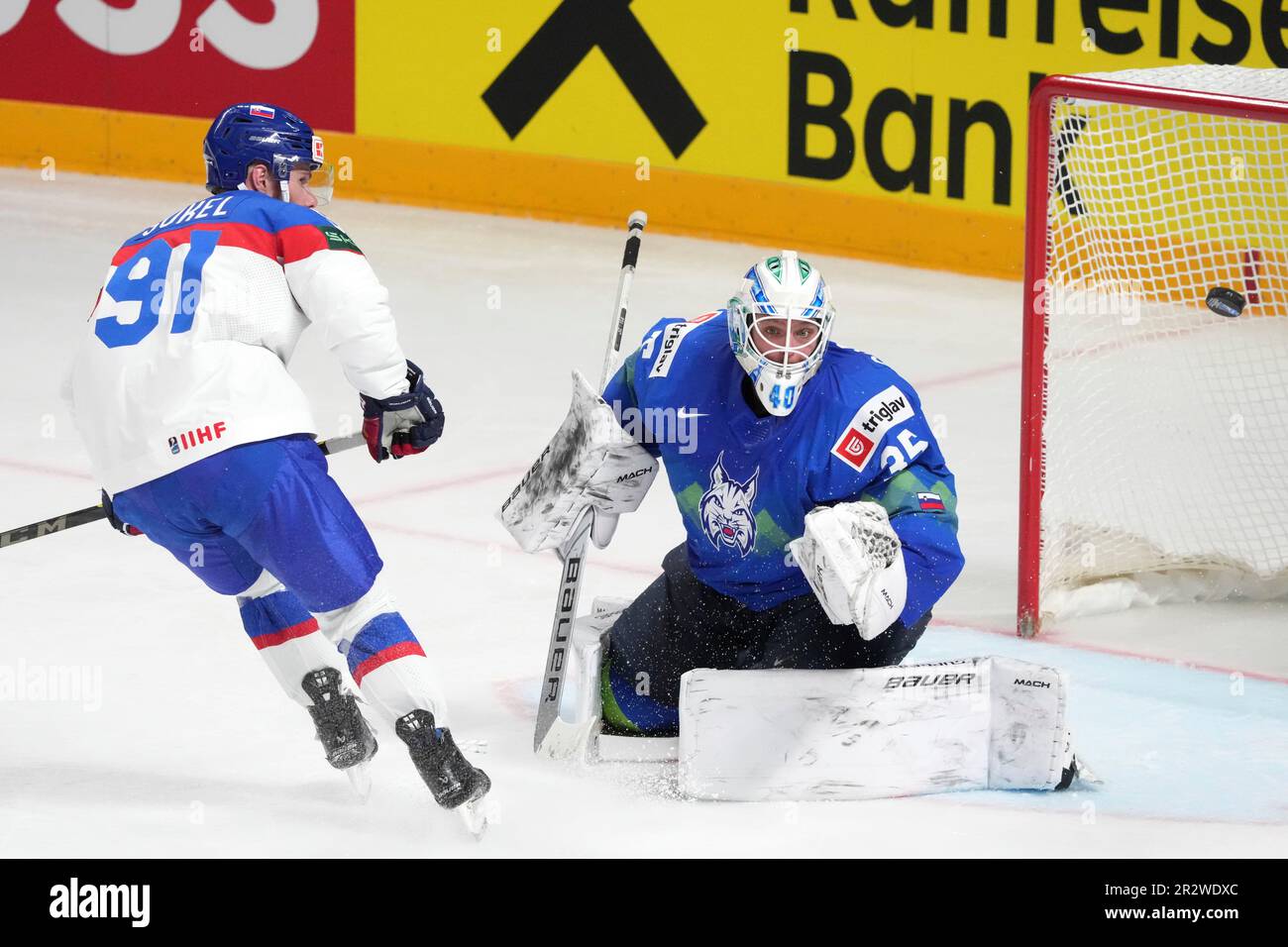 Goalie Luka Gracnar of Slovenia, right, fights for a puck with Matus ...