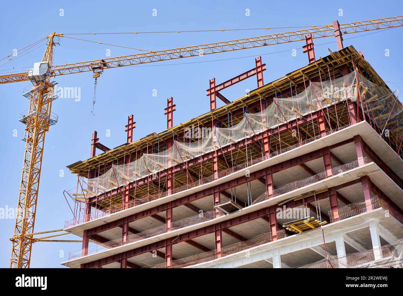 Hydraulic luffing jib tower cranes and workers being poured concrete ...