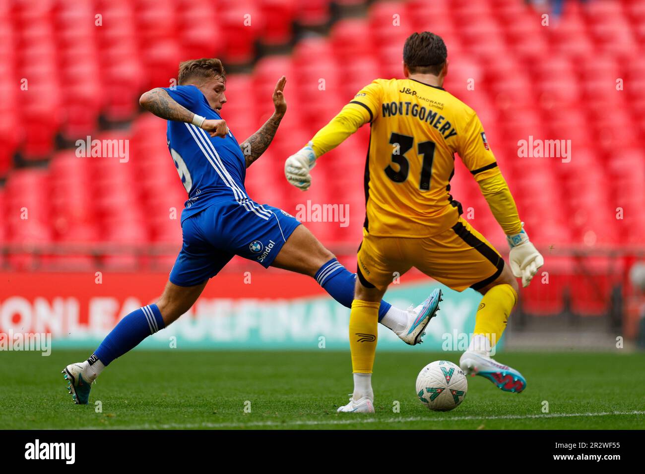 London, UK. 21st May, 2023. Jamie Cooke (19 Halifax Town) blocks a pass ...