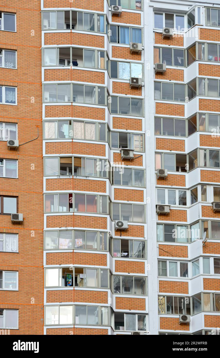 Front of modern residential multi-storey building with many windows and ...
