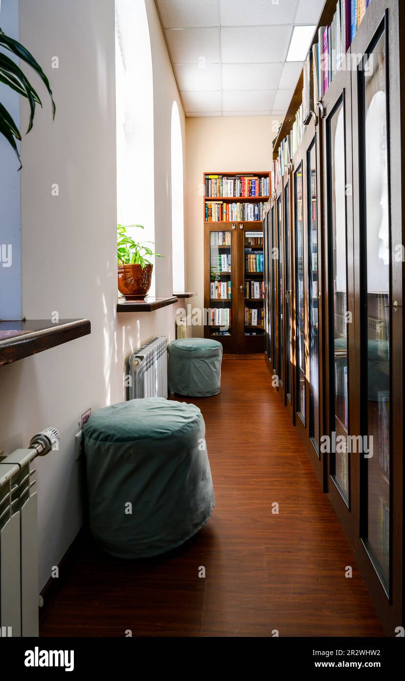 Shelves and cabinets with books in the library opposite the wall with ...
