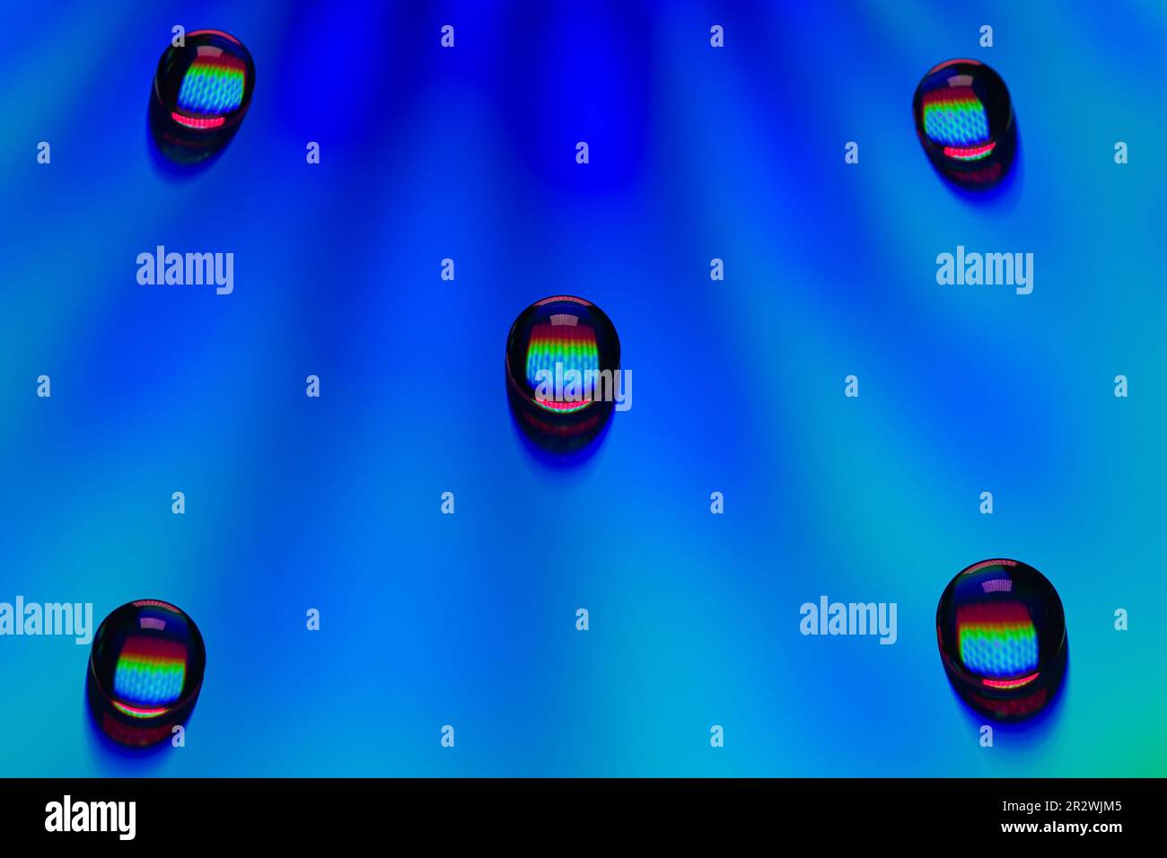 Waterdrops on a CD with blue light Stock Photo - Alamy