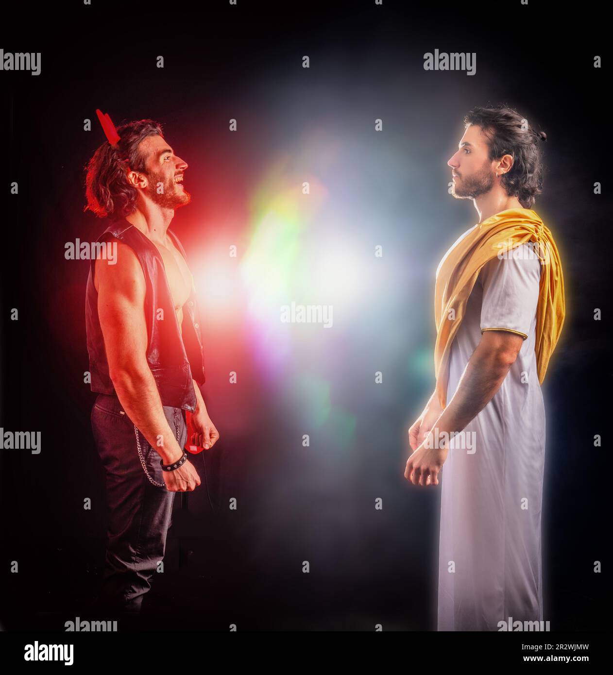 Angel and devil standing against each other Stock Photo - Alamy