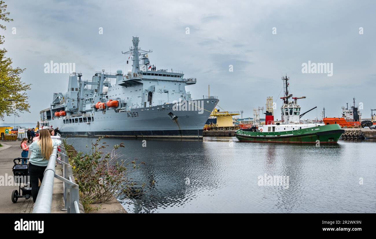 people watching arrival of RFA Forth Victoria naval ship towed by a ...