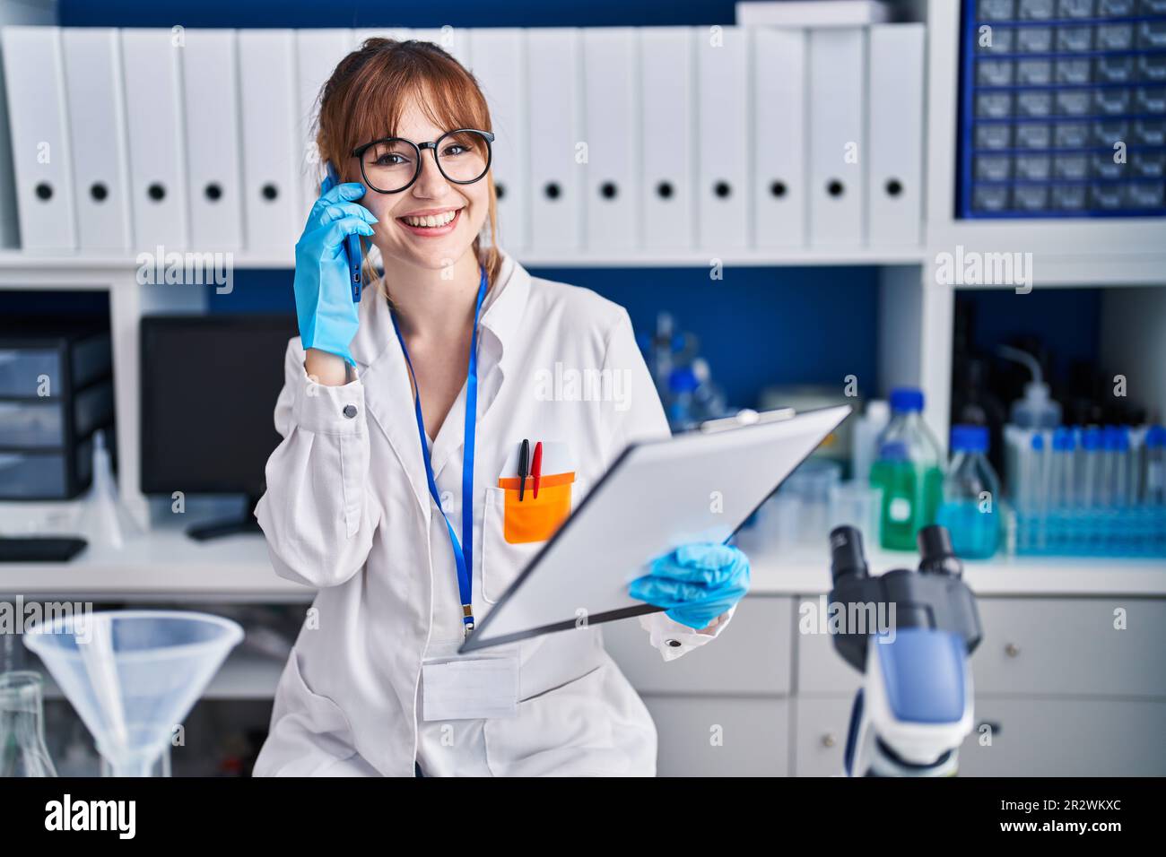 Young woman scientist smiling confident talking on the smartphone at laboratory Stock Photo - Alamy