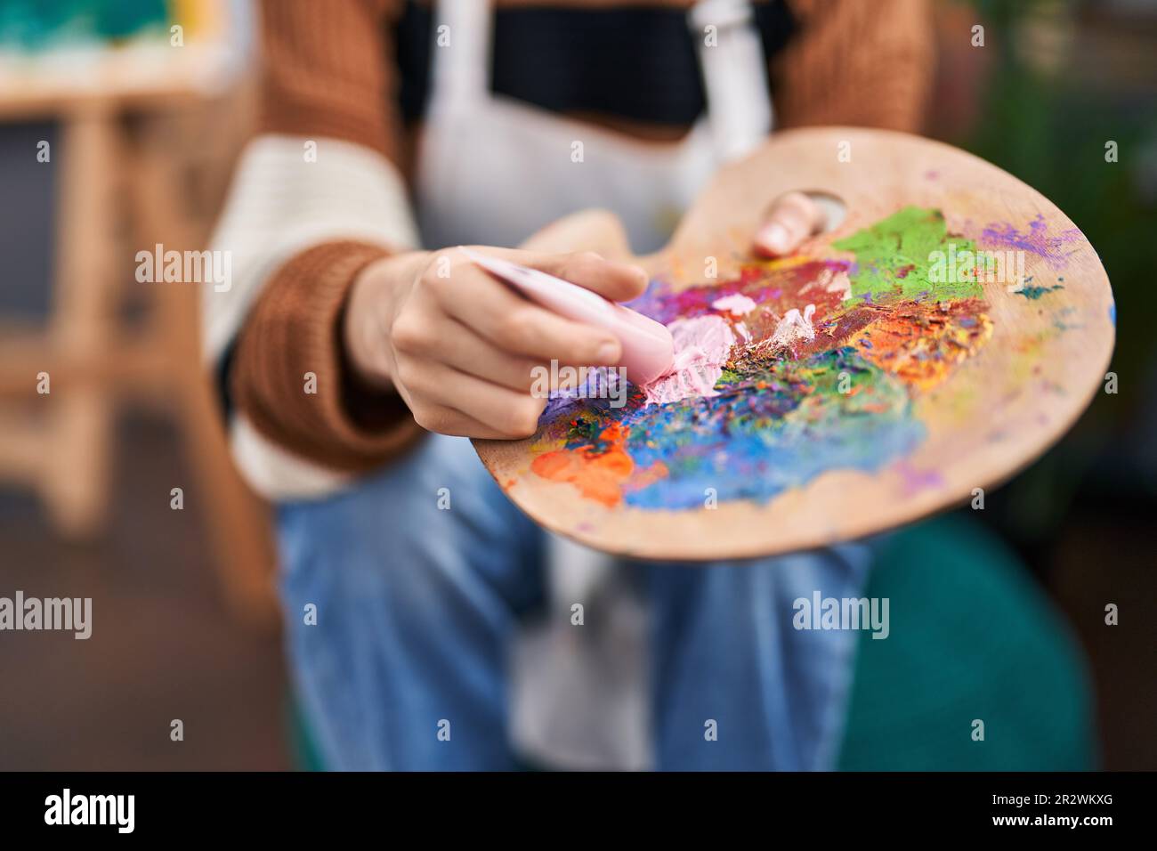 Young woman artist mixing color on palette at art studio Stock Photo ...