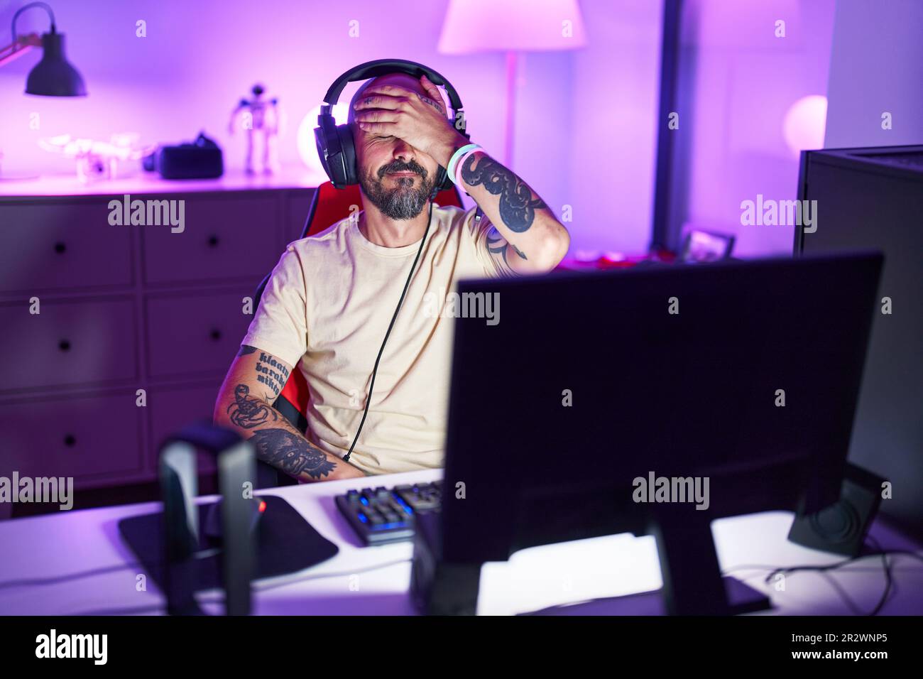 Young bald man streamer stressed using computer at gaming room Stock ...