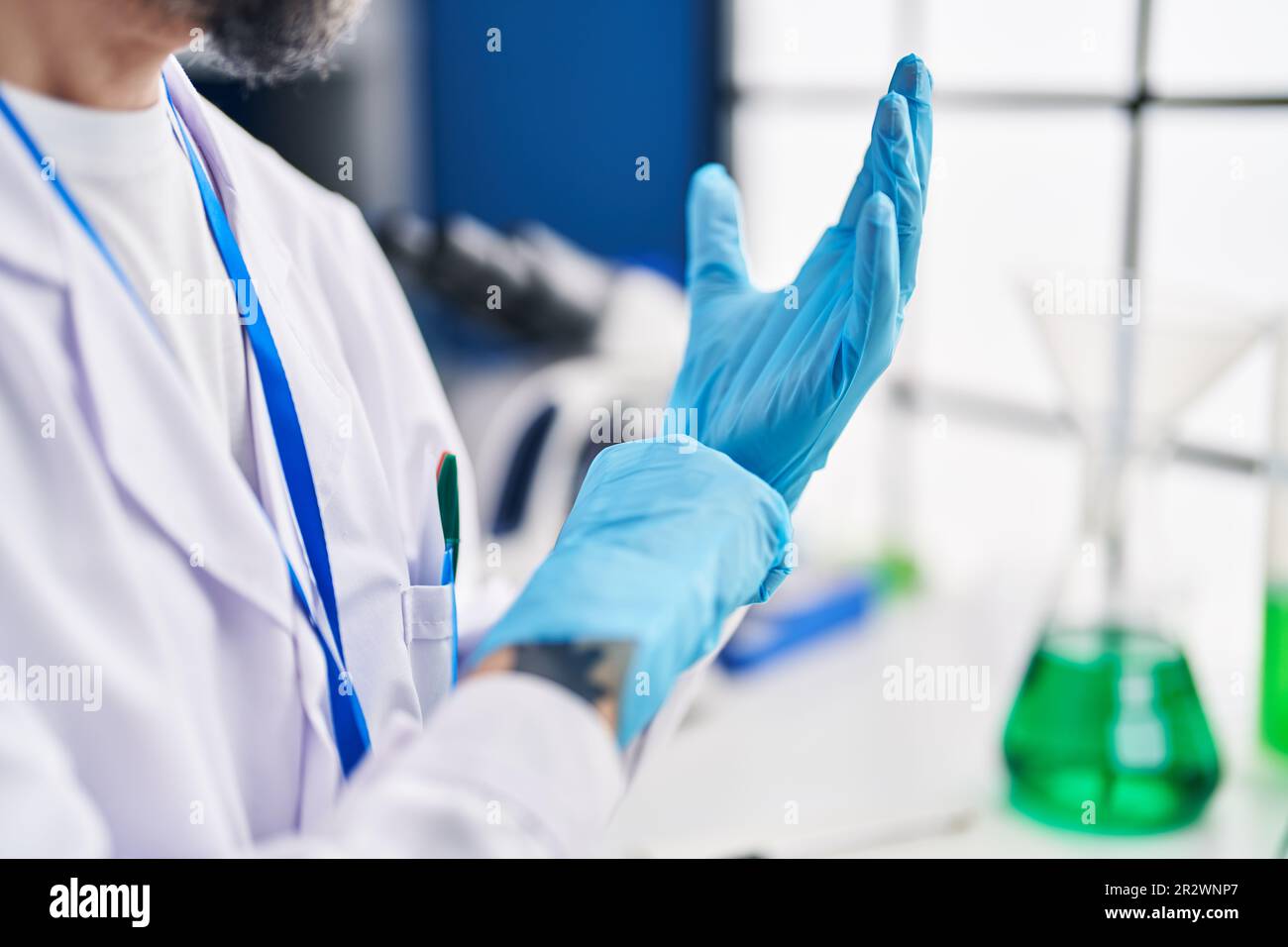 Young bald man scientist wearing gloves at laboratory Stock Photo - Alamy