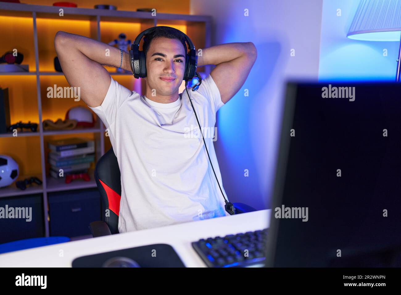 Young hispanic man streamer smiling confident relaxed with hands on ...