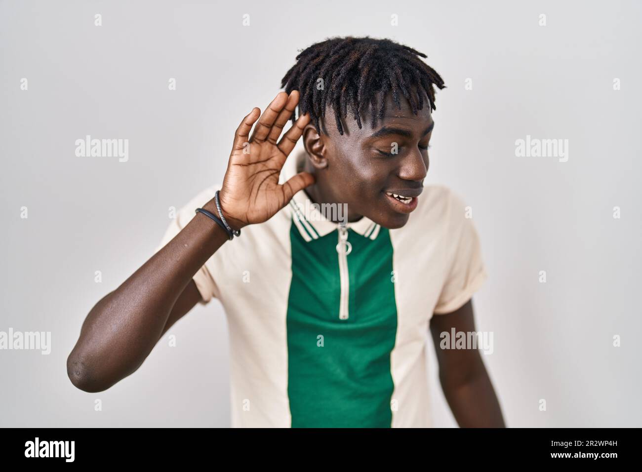 African man with dreadlocks standing over isolated background smiling ...