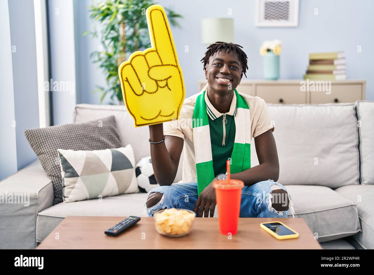 African man with dreadlocks football hooligan supporting team looking ...