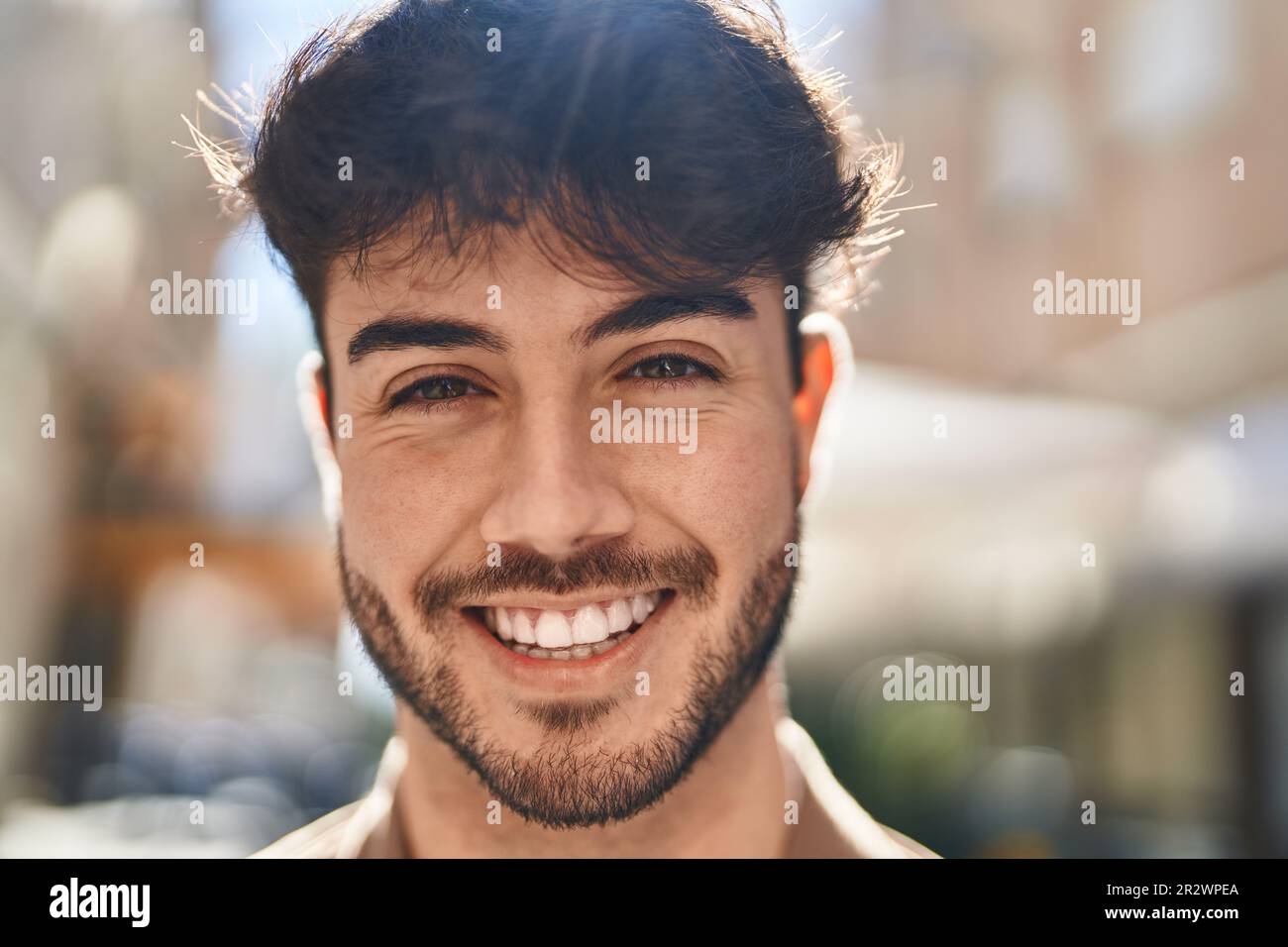 Young hispanic man smiling confident standing at street Stock Photo - Alamy