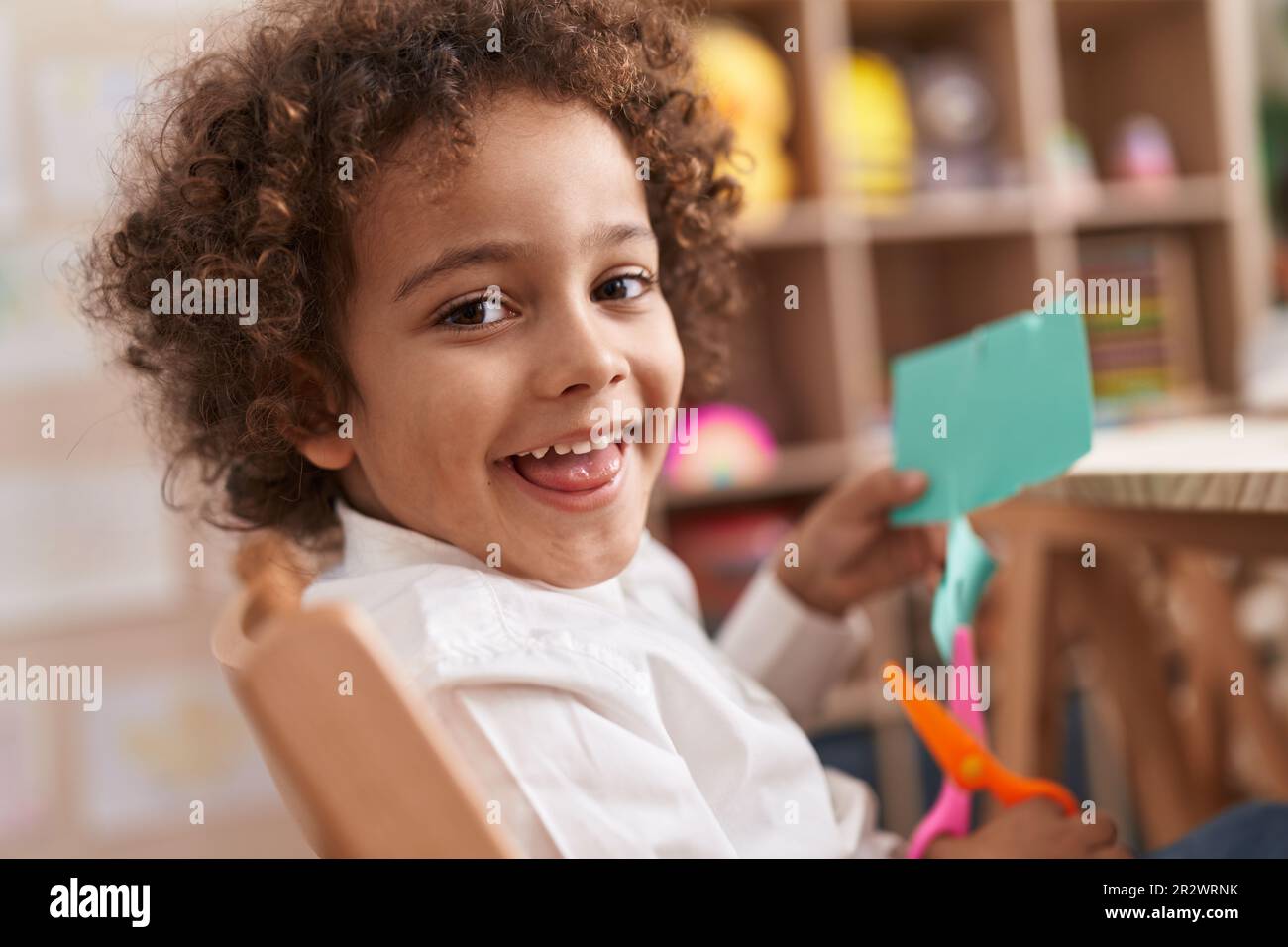 African american boy student smiling confident cutting paper at ...